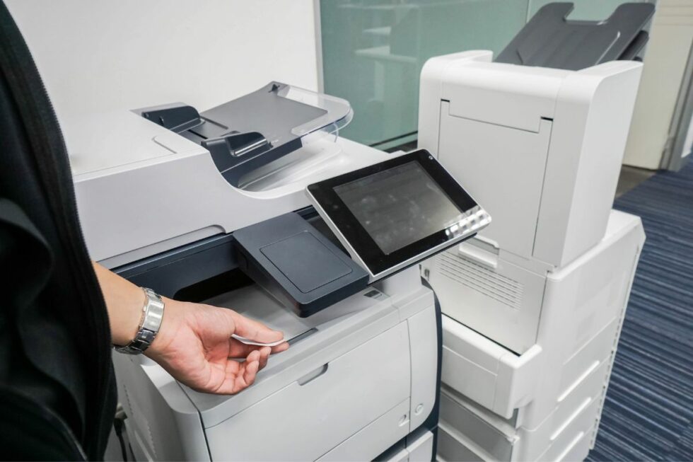 What are the benefits of leasing or buying a production printer?